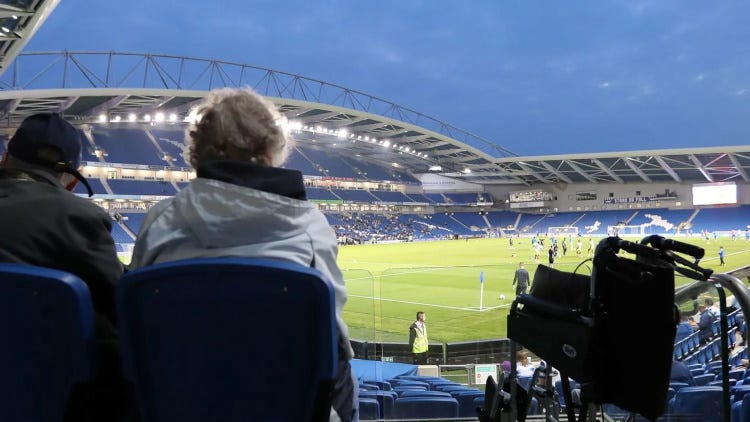 supporters sitting in a wheelchair area at the amex stadium